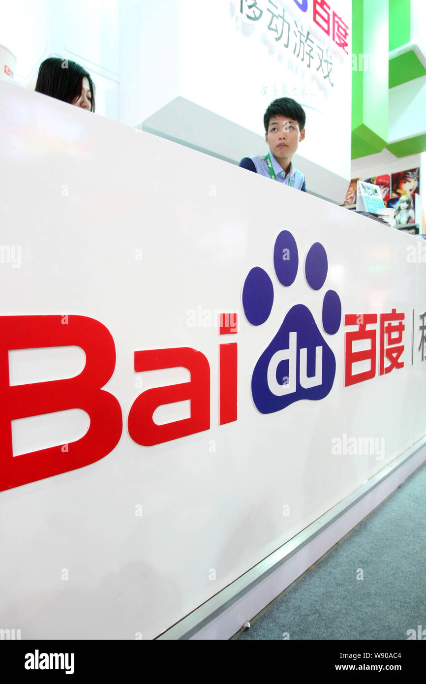 --FILE--Chinese employees are seen at the stand of Baidu during a fair ...