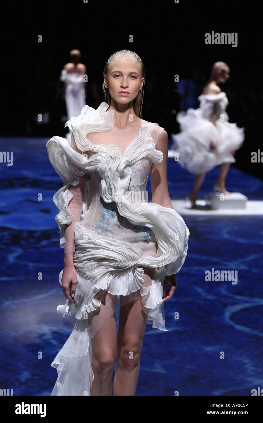 A model displays a new creation by Lan Yu at its Fall/Winter 2014 Haute ...