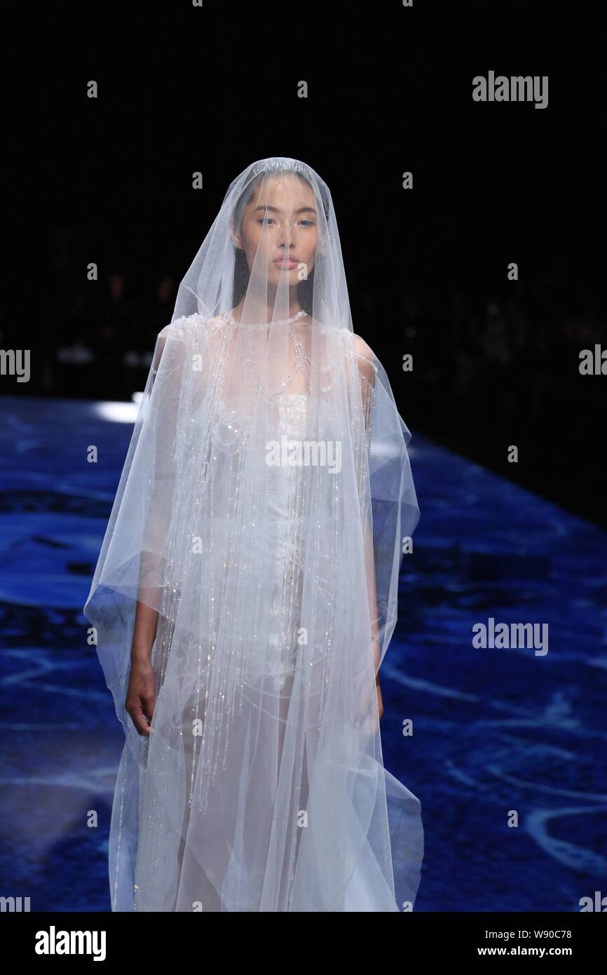 A model displays a new creation by Lan Yu at its Fall/Winter 2014 Haute ...