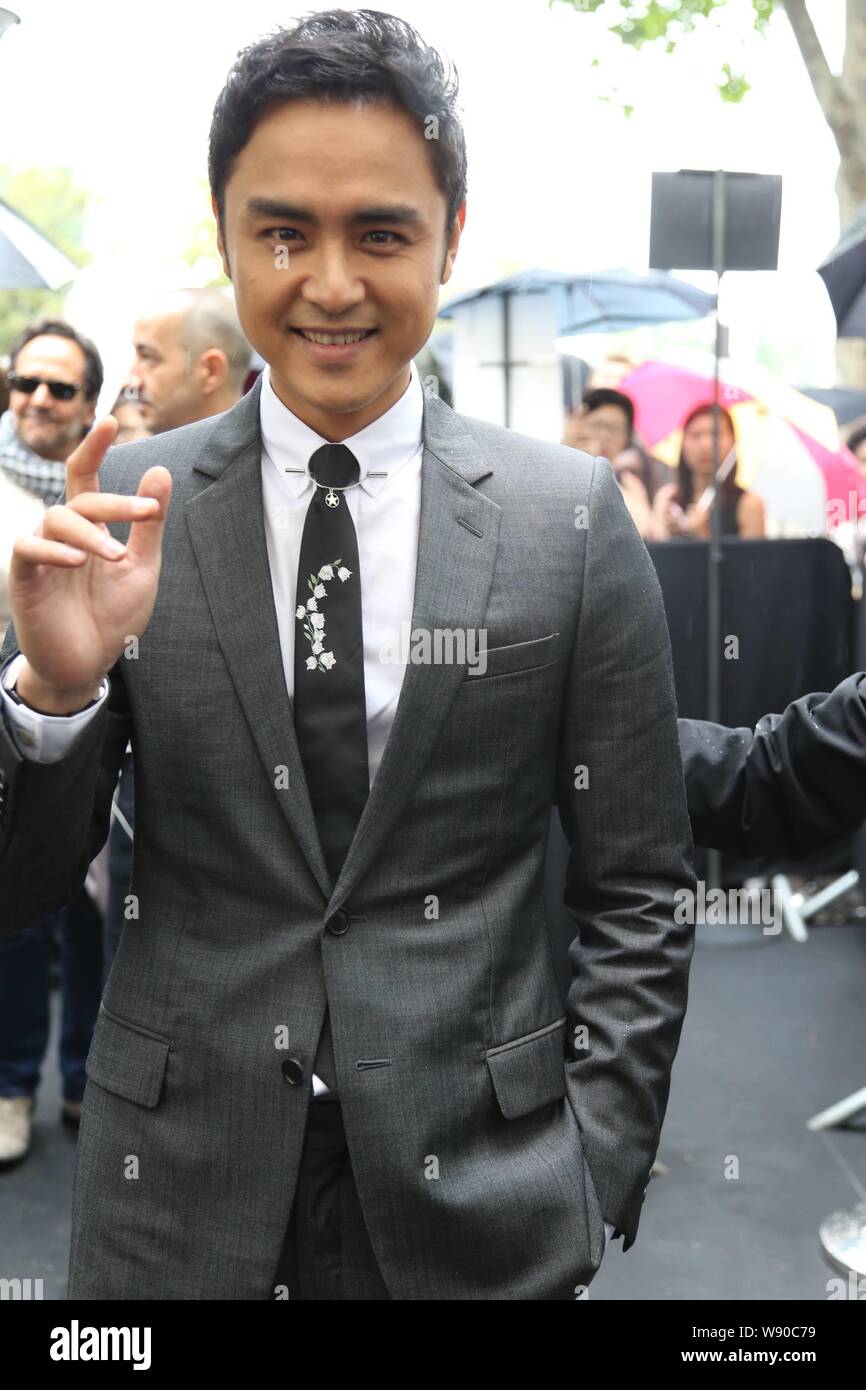 Taiwanese actor Ming Dow smiles as he arrives at Dior Homme Fashion ...