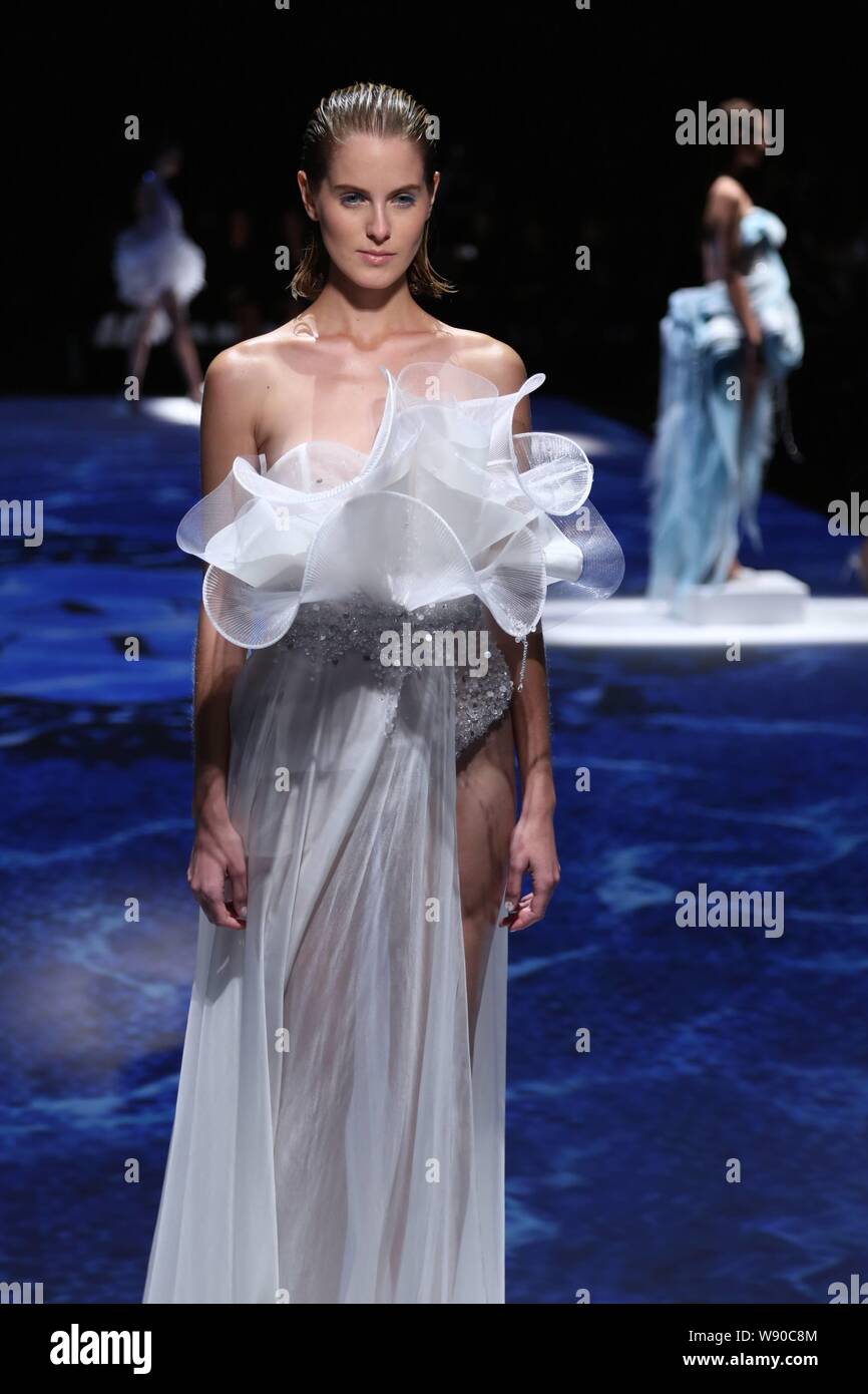 A model displays a new creation by Lan Yu at its Fall/Winter 2014 Haute ...
