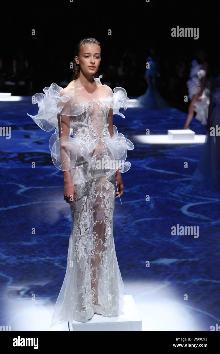 A model displays a new creation by Lan Yu at its Fall/Winter 2014 Haute ...