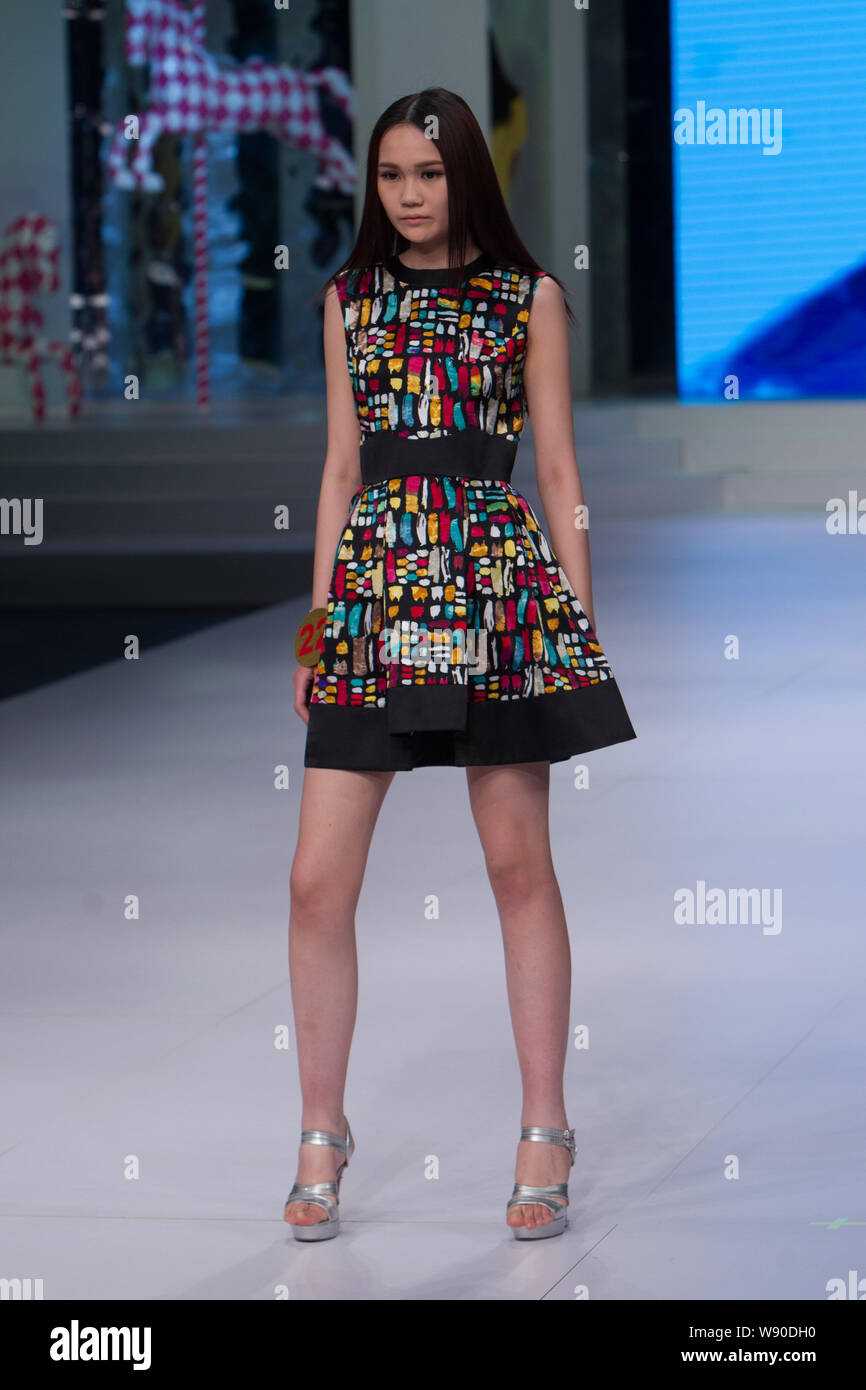 A model displays a new creation at the Final of the 9th China Super ...