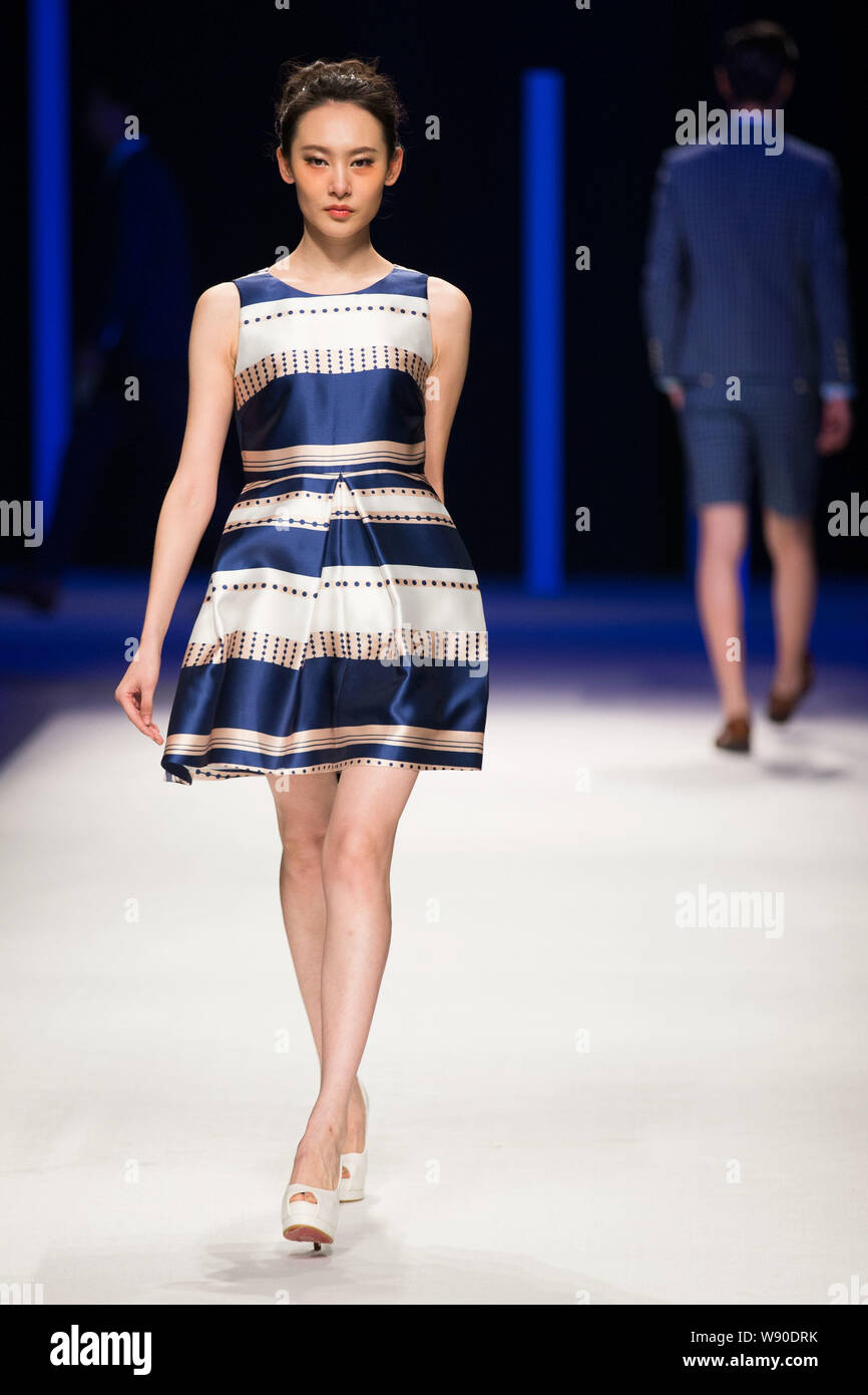 A model displays a new creation by designer Yuan Bing at the VISCAP ...