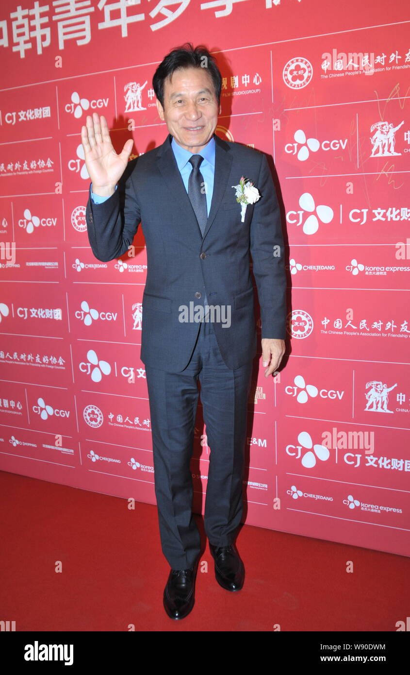 South Korean actor Ahn Sung-kee poses on the red carpet as he arrives ...