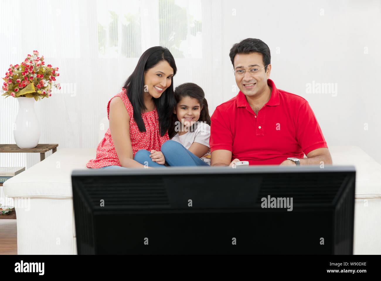 Family watching tv at home Stock Photo - Alamy