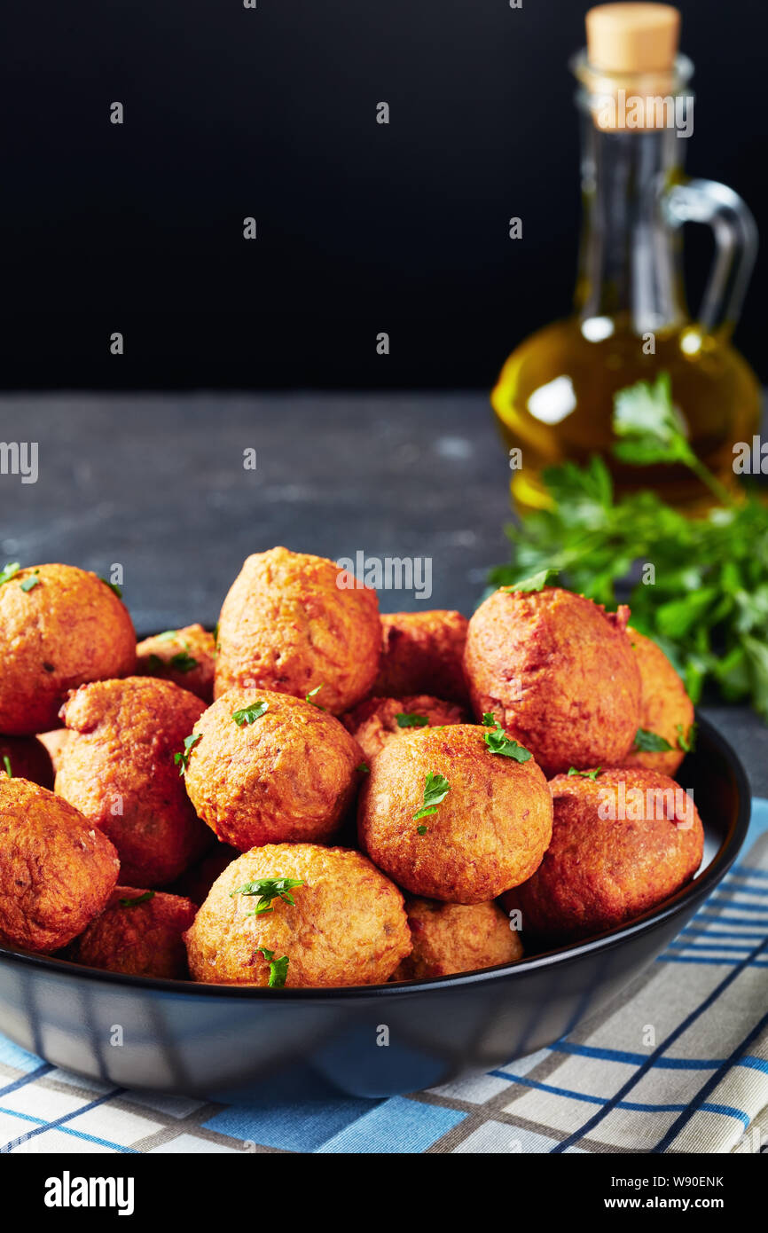 close-up of deep fried Plantain croquettes Klako in a black bowl with ...