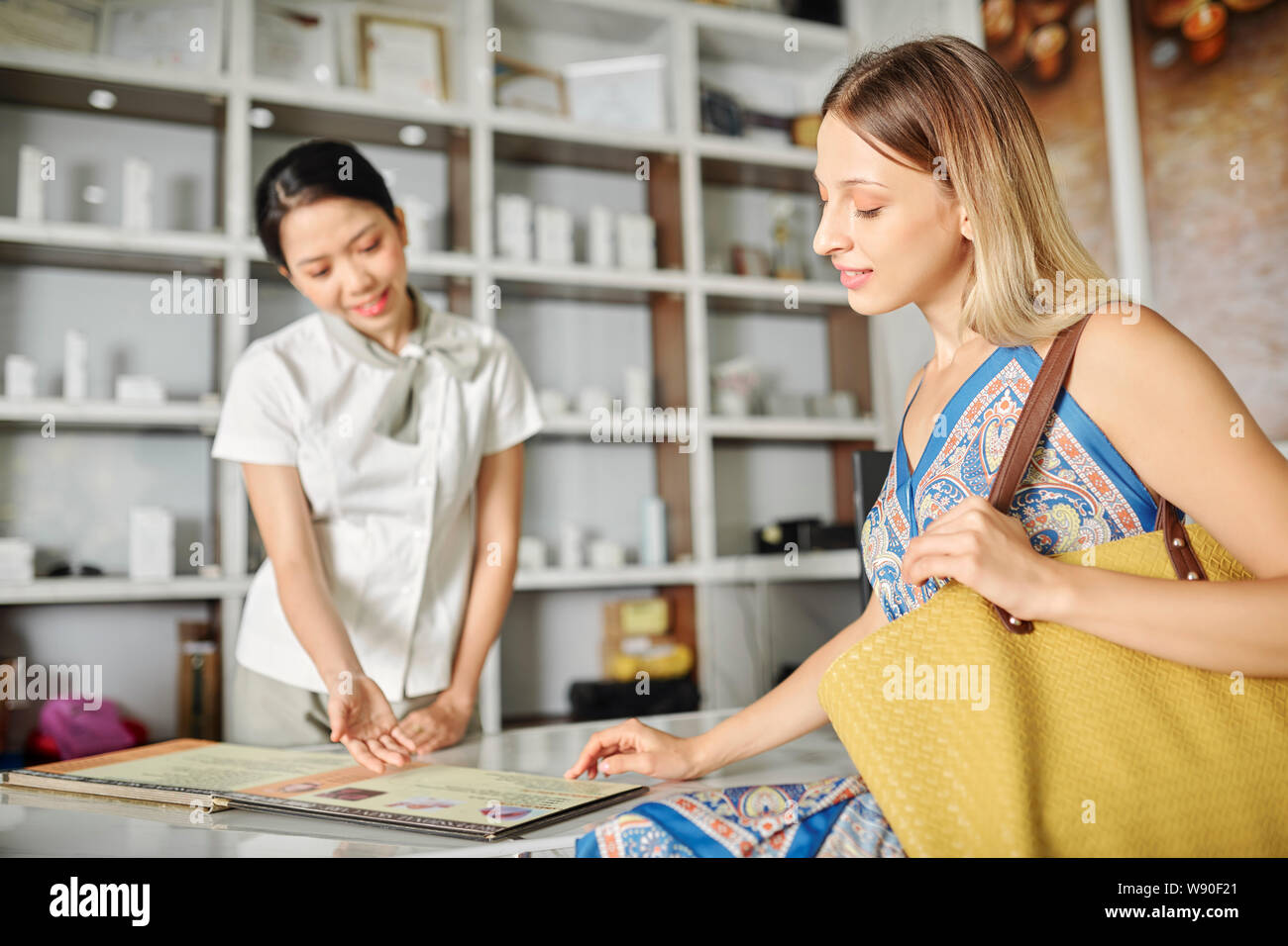 Spa salon client choosing procedure Stock Photo - Alamy