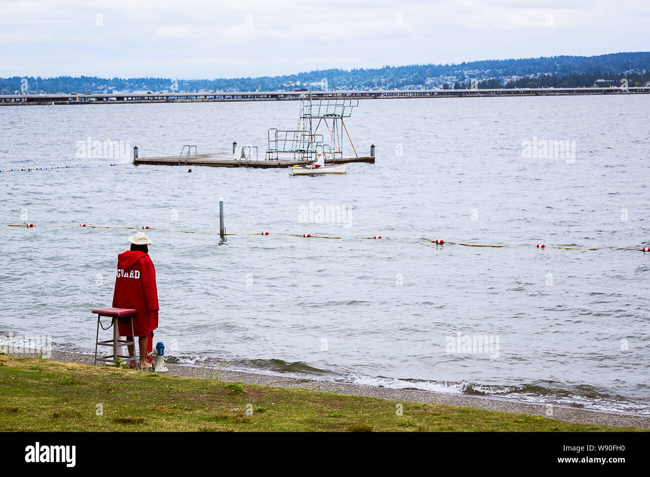 A cold female lifeguard on the beach at Madison Park, Seattle Stock ...