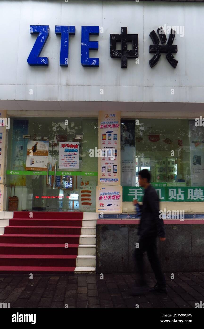 --FILE--A pedestrain walks past a branch of ZTE in Yichang city, south ...