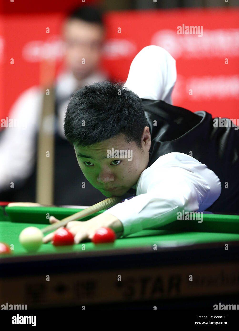 Ding Junhui of China plays a shot against John Astley of England during ...