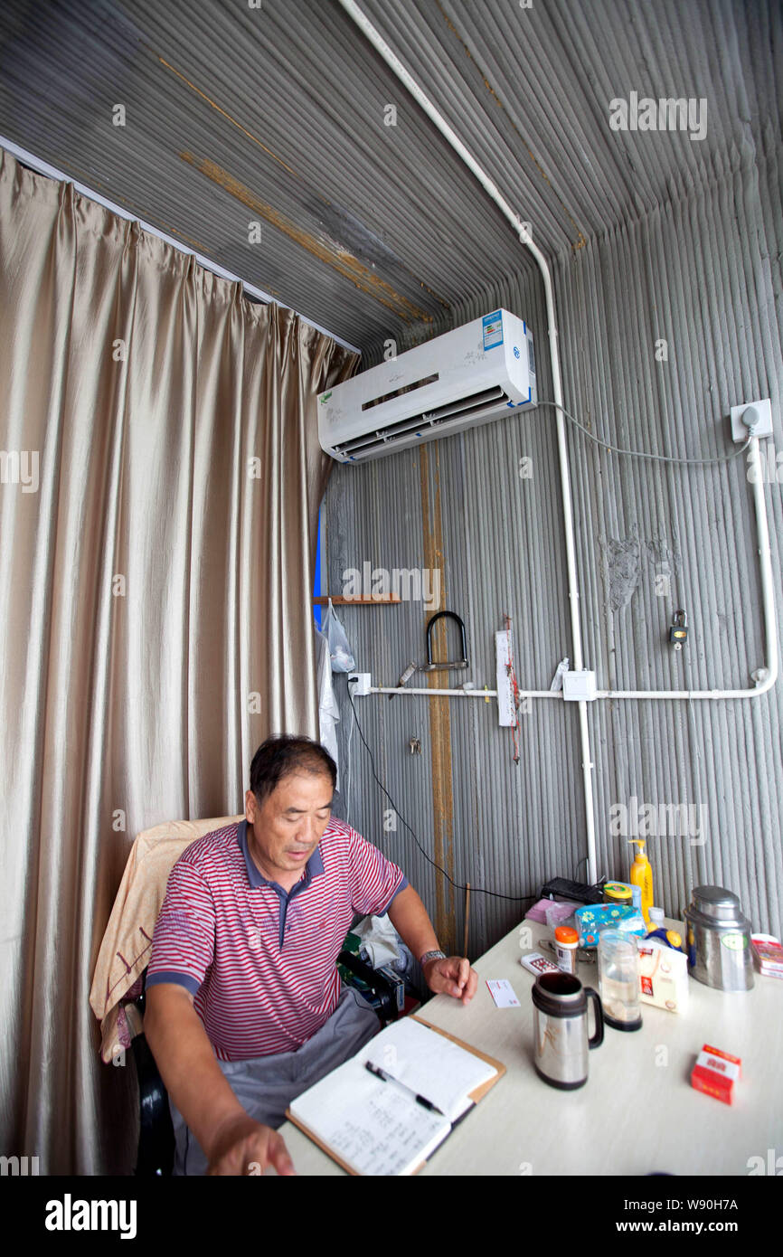 A man works inside one of the ten 3D printed houses at the Qingpu Park ...
