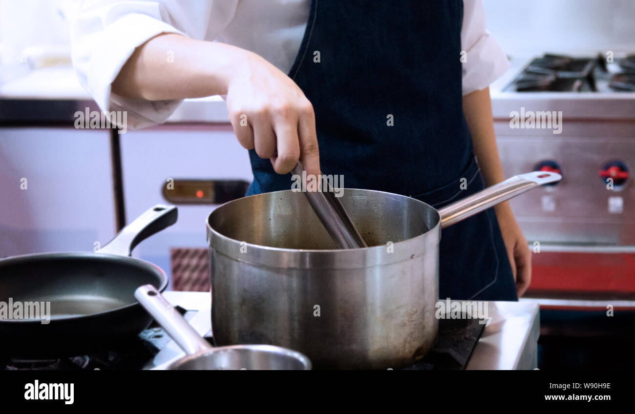 Chef cooking food in the kitchen, Chef preparing food Stock Photo - Alamy