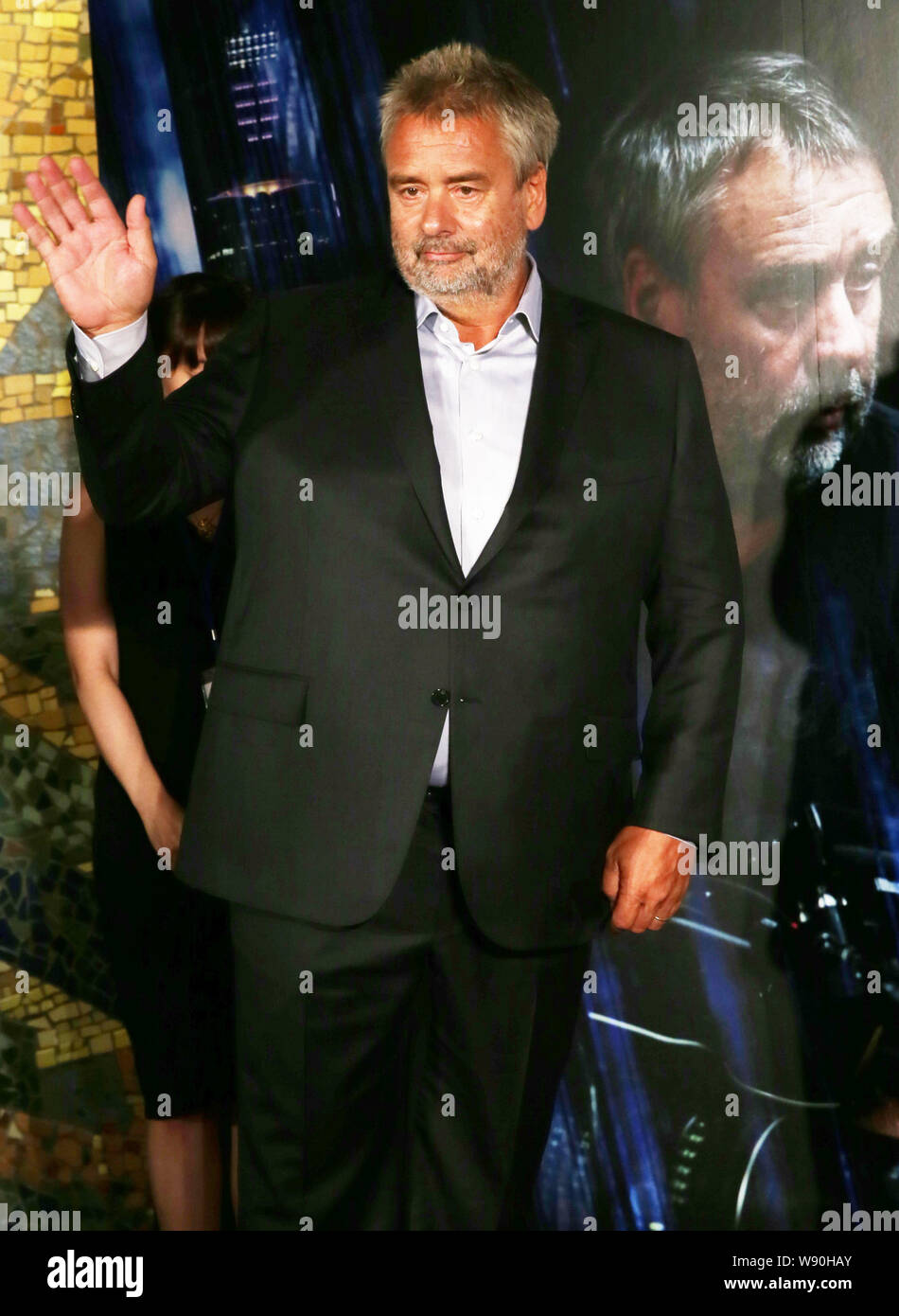 French director Luc Besson waves at a premiere for his movie, Lucy, in ...