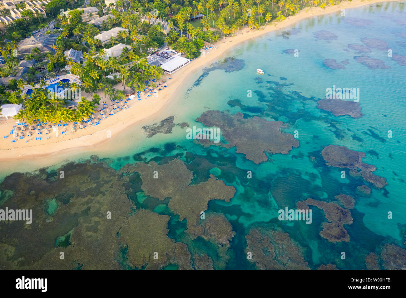 Drone shot of tropical beach with white boat anchored.Samana peninsula ...