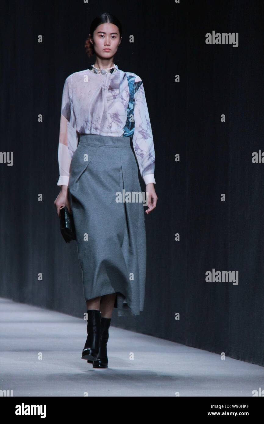 A model displays a new creation at the MO&Co. Fall/Winter 2014 fashion ...