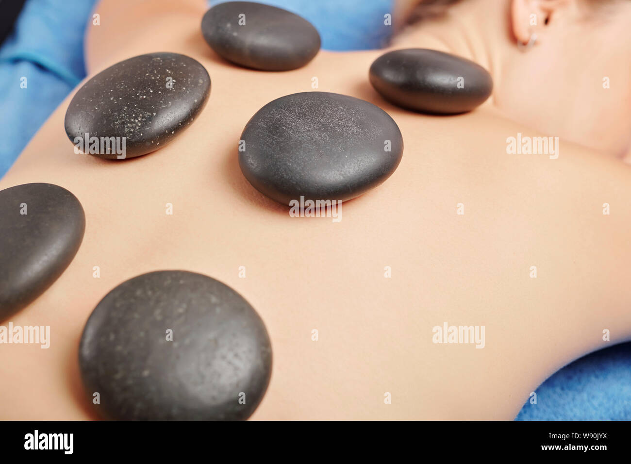 Heated basalt stones on back Stock Photo - Alamy
