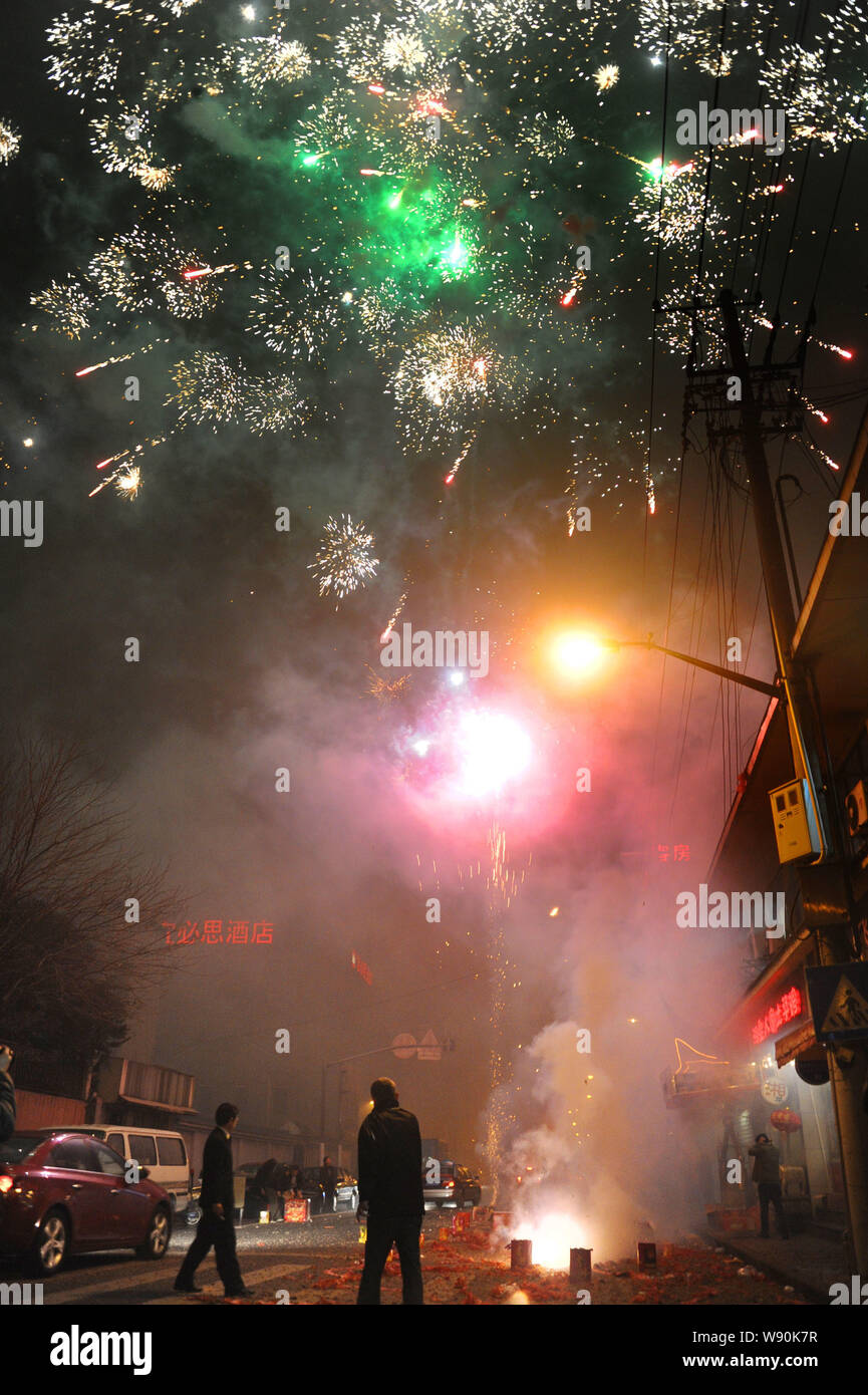 Local residents set off fireworks on a street on the Chinese Lunar New ...