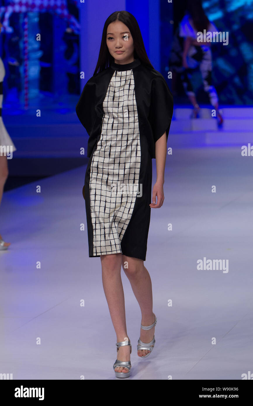 A model displays a new creation at the Final of the 9th China Super ...