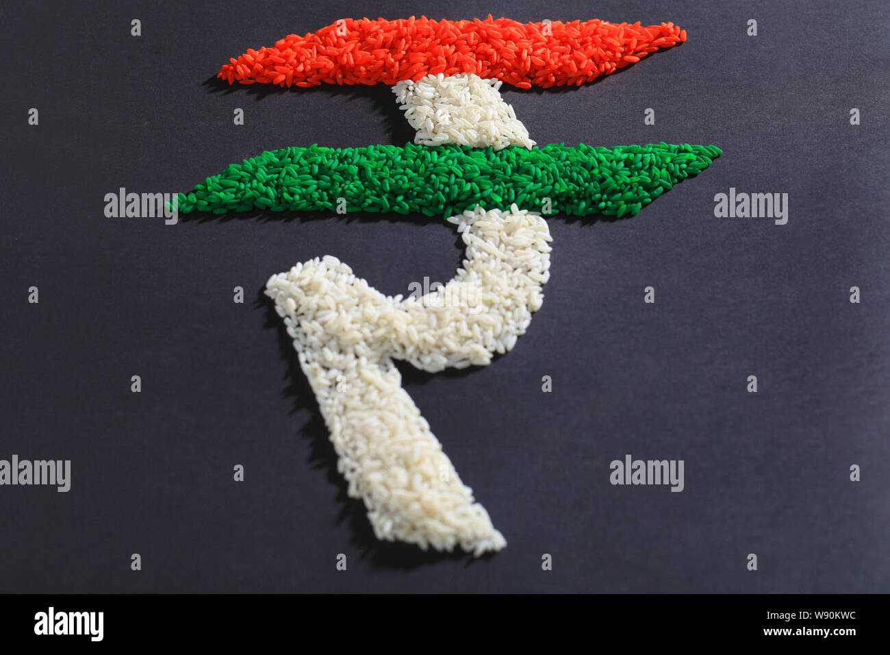 Indian rupee symbol made of rice and representing Indian Flag Stock ...
