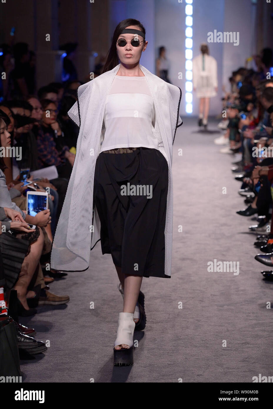 A model displays a new creation at the Simon Gao Spring/Summer 2015 fashion show in Shanghai ...