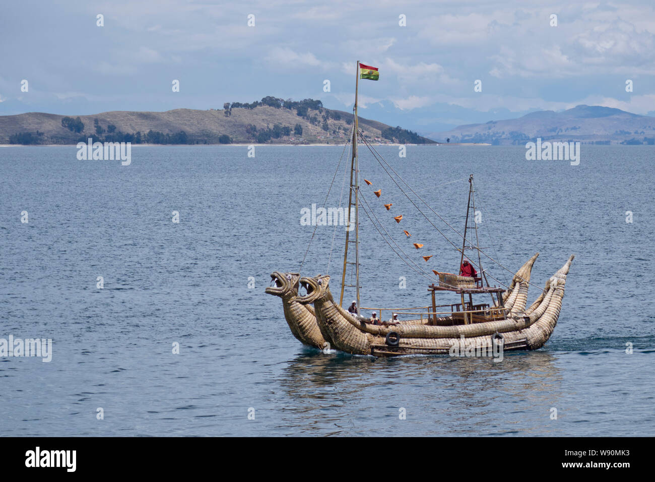 Traditional reed boat with tourists by Island of the Sun on Lake ...