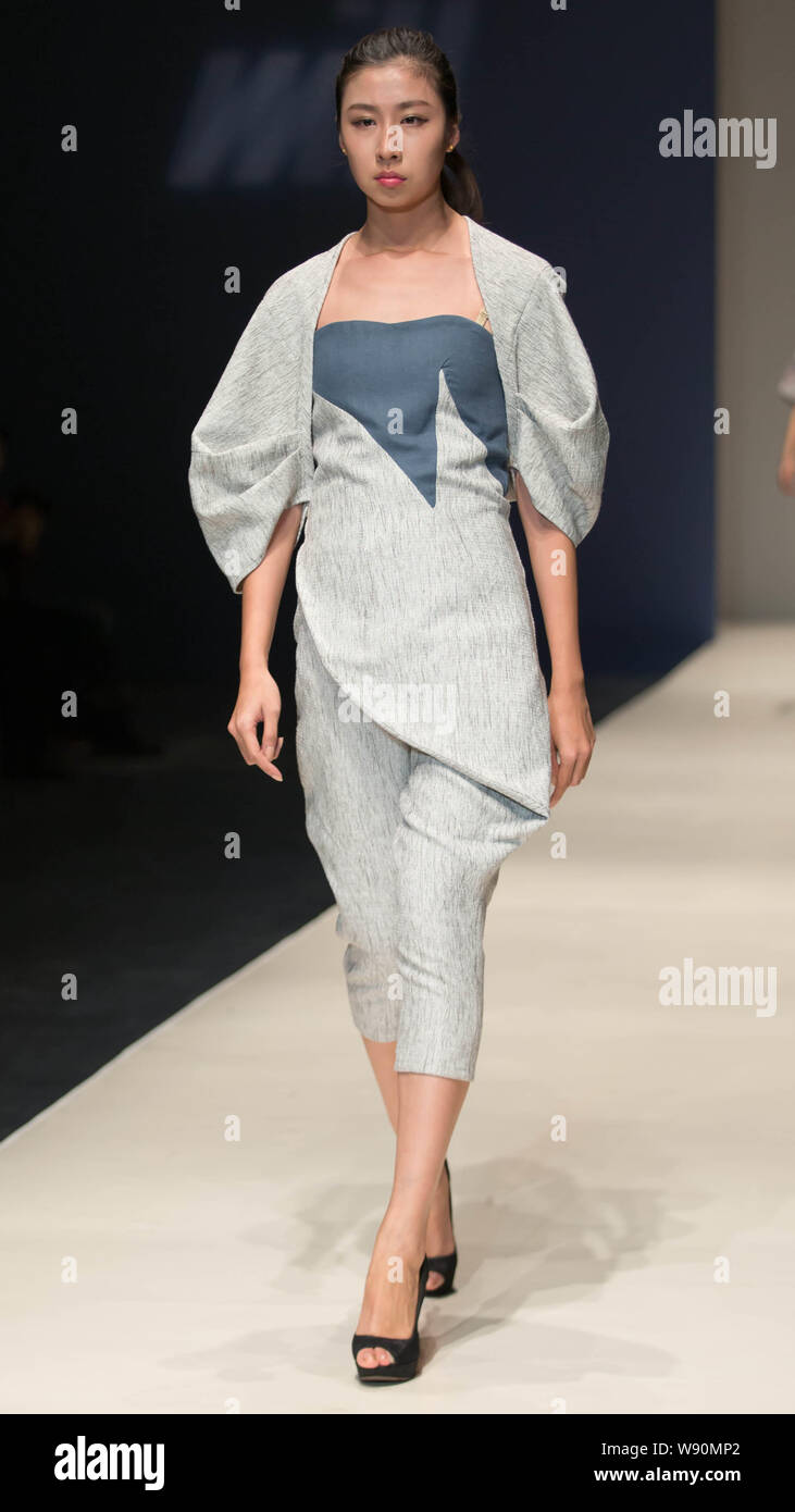 A model displays a creation by a postgraduate at a fashion show for ...