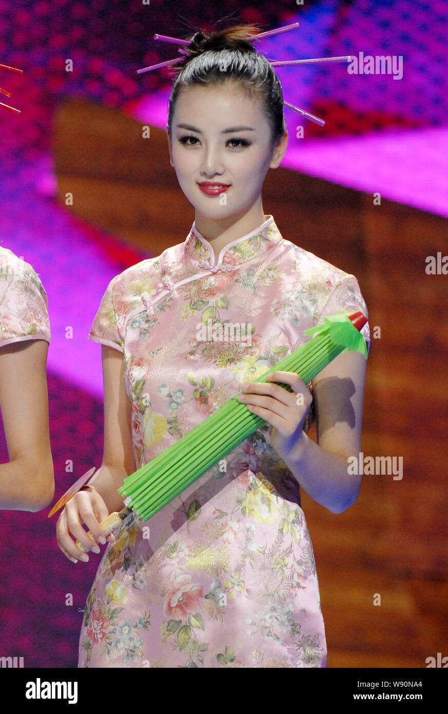 Chinese model Huo Jialin displays a creation of cheongsam, also known ...