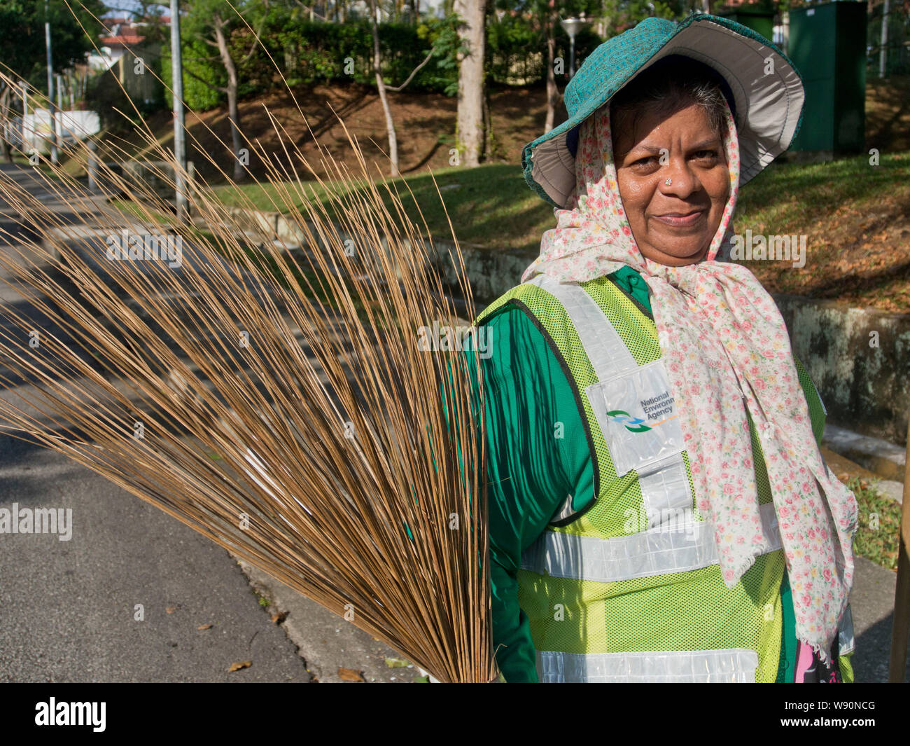 Woman street cleaner in Singapore Stock Photo - Alamy