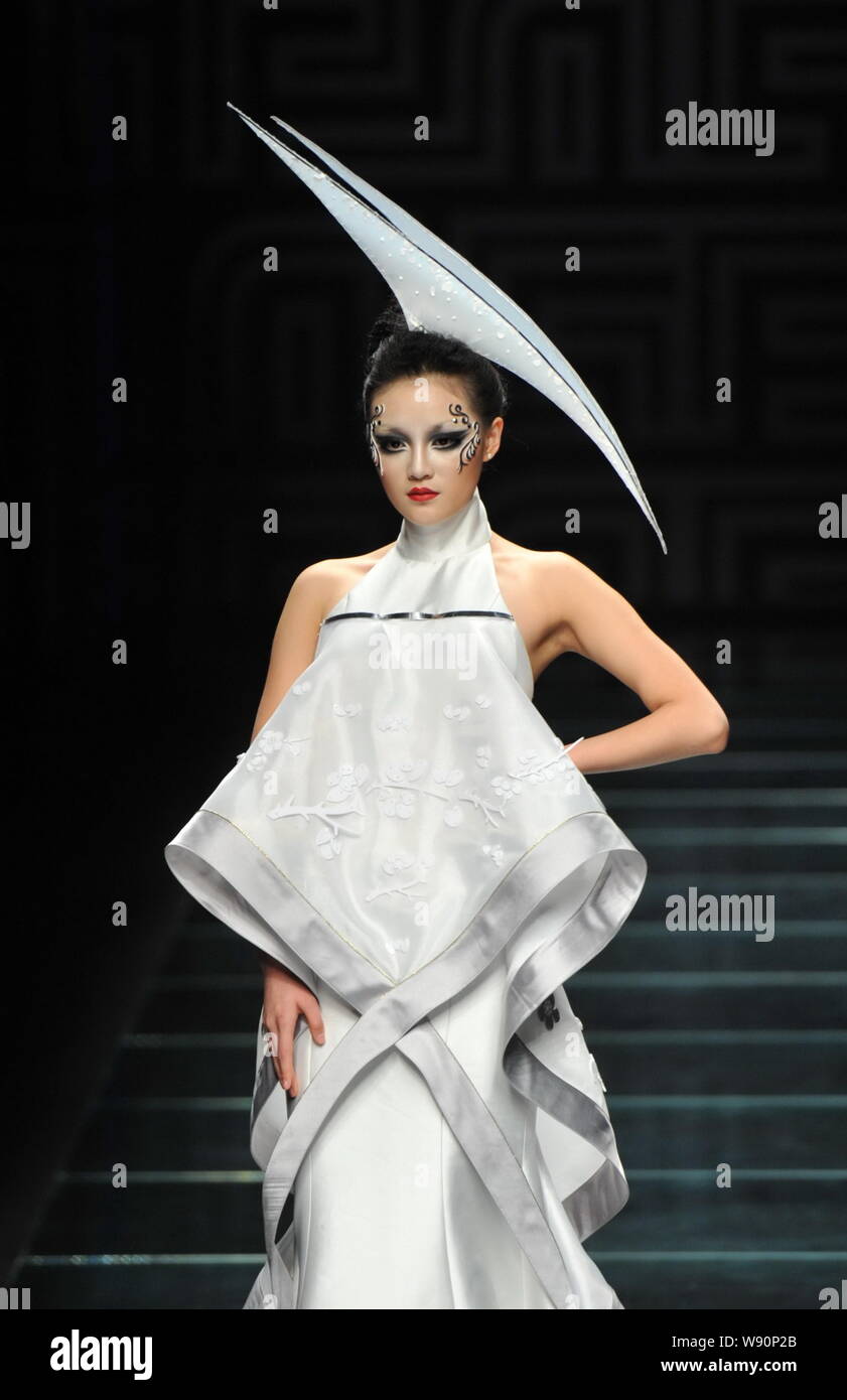 A model displays a new creation by designer Mao Geping at the MGPIN ...