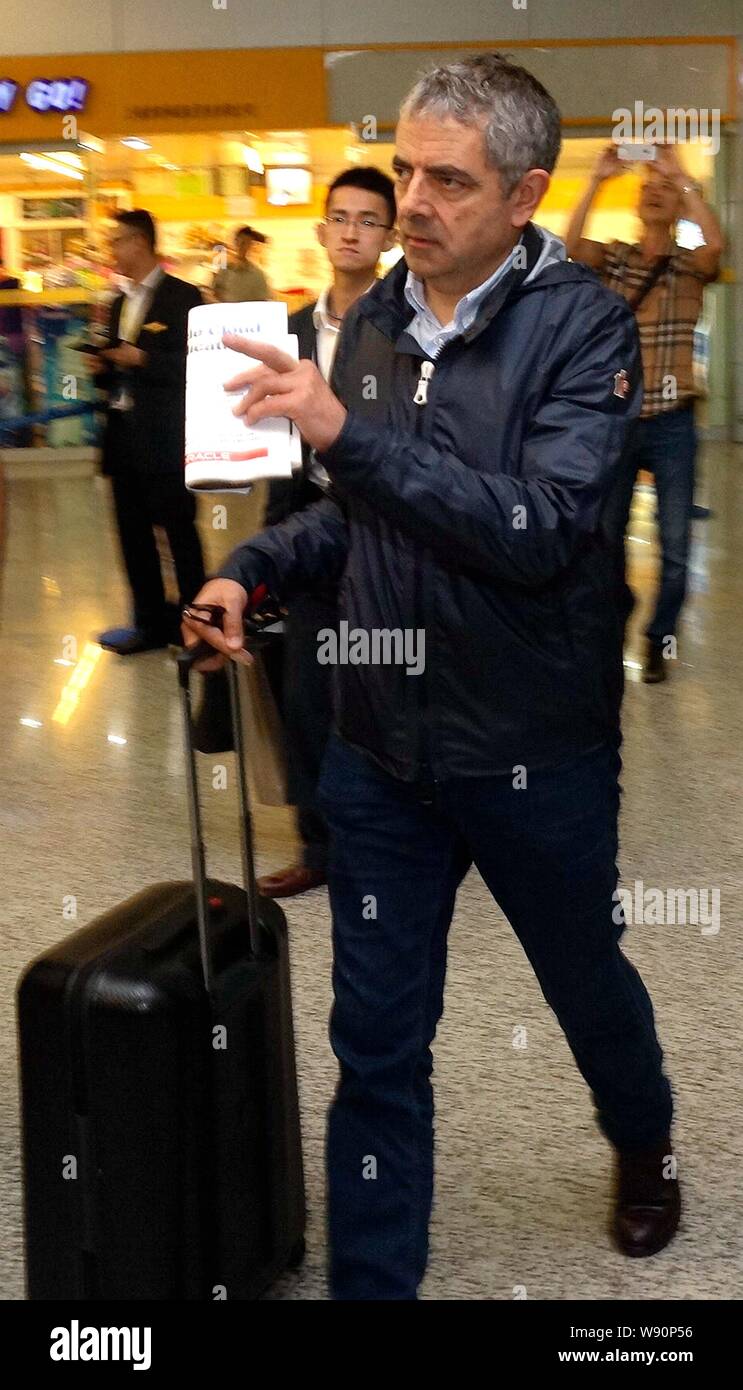 English actor Rowan Atkinson, front, arrives at the Shanghai Pudong ...