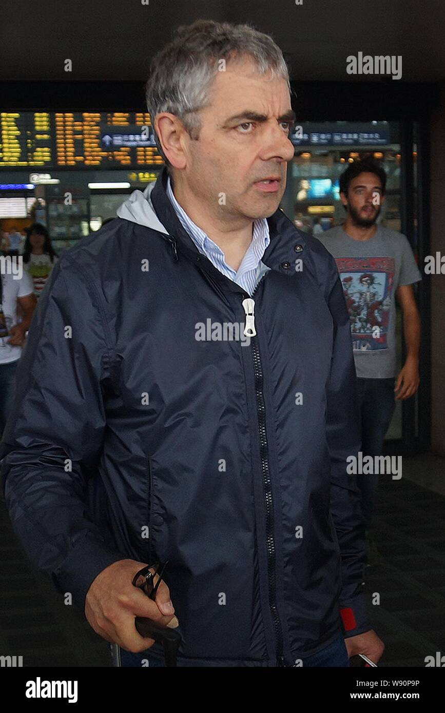 English actor Rowan Atkinson, front, arrives at the Shanghai Pudong ...
