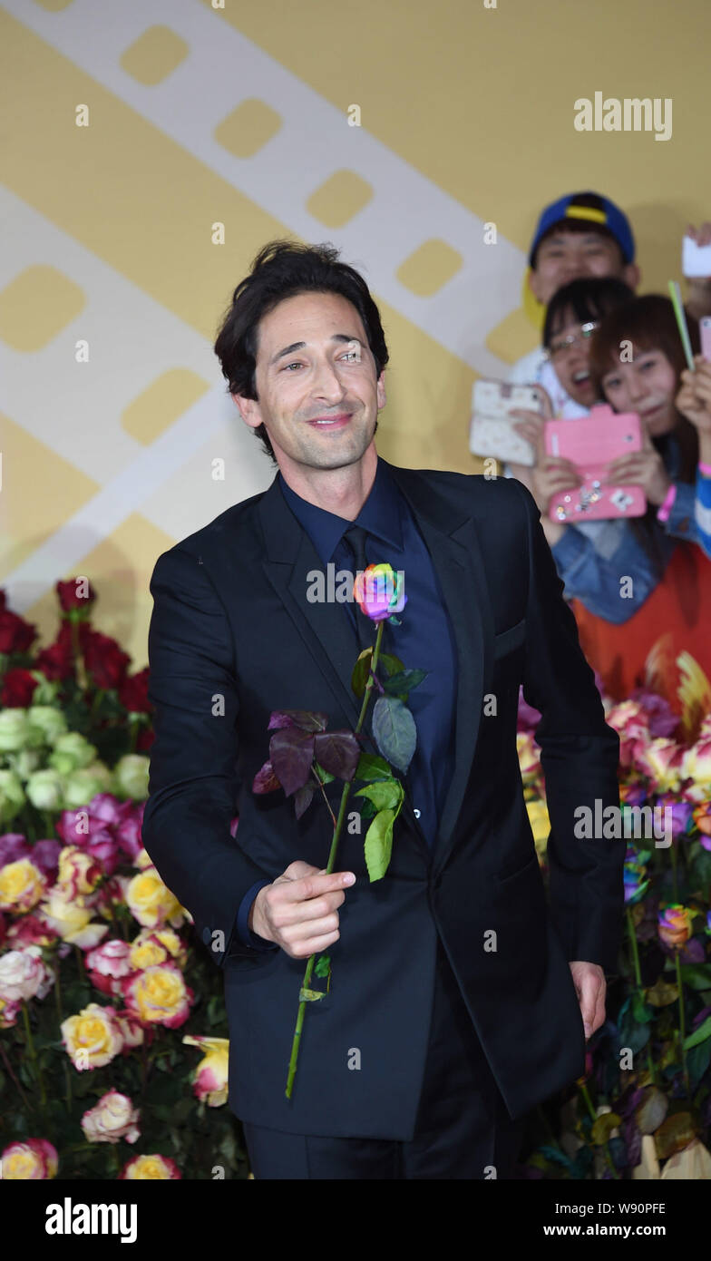 American actor Adrien Brody poses with a colorful rose on the red ...