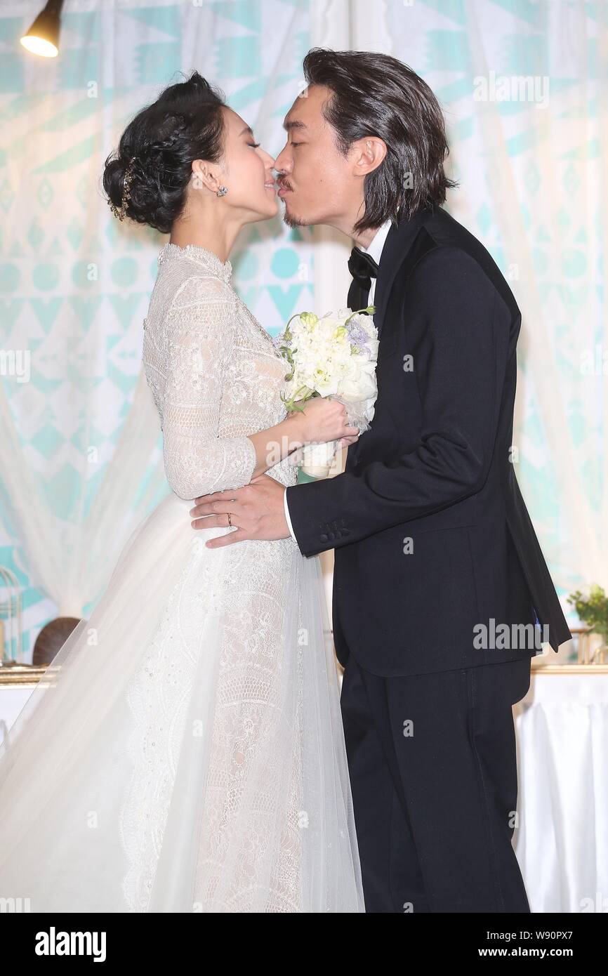 Malaysian singer Penny Tai, left, kisses her Taiwanese husband Sidney ...