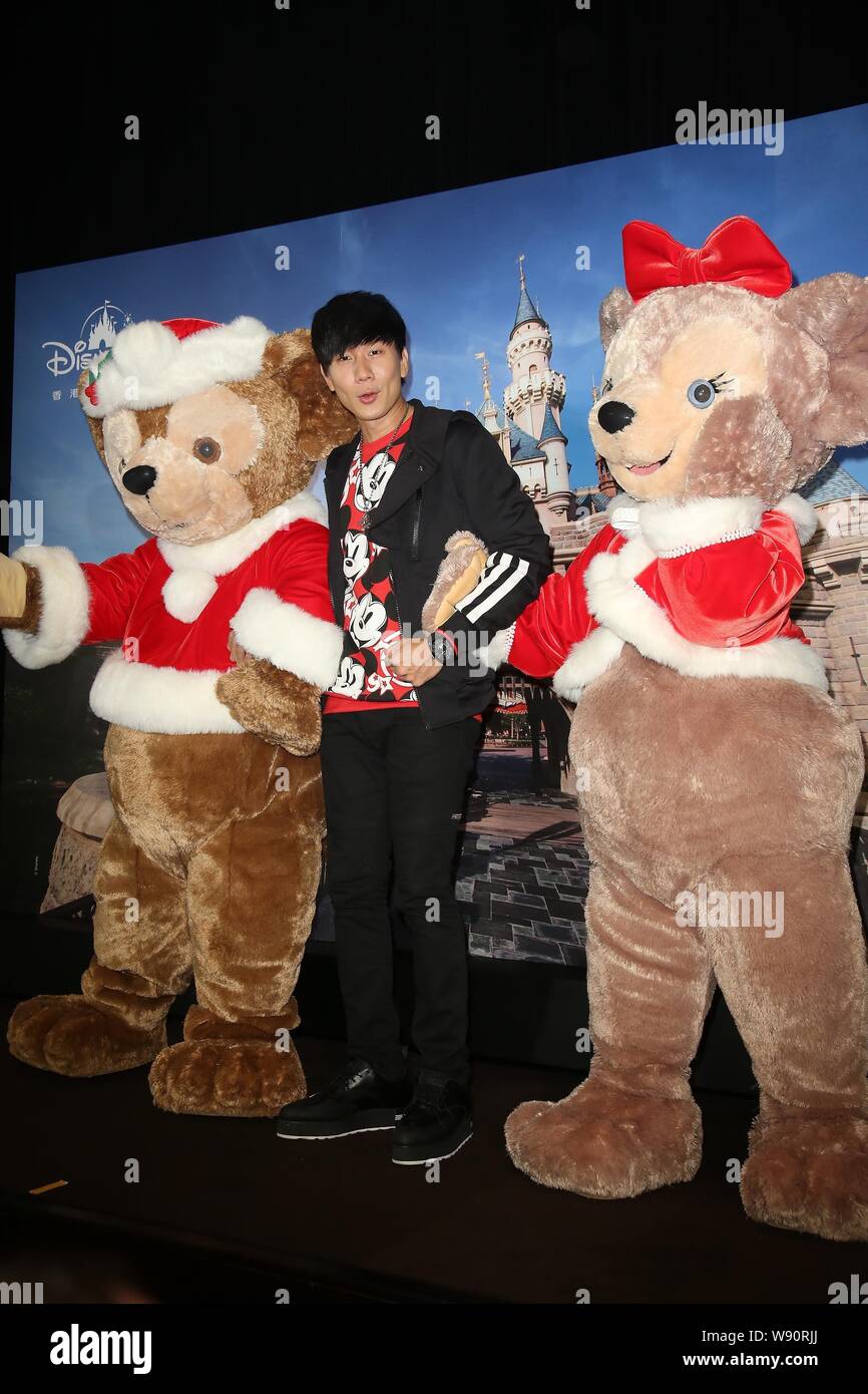 Singaporean singer JJ Lin, center, poses with two mascot bears at a ...