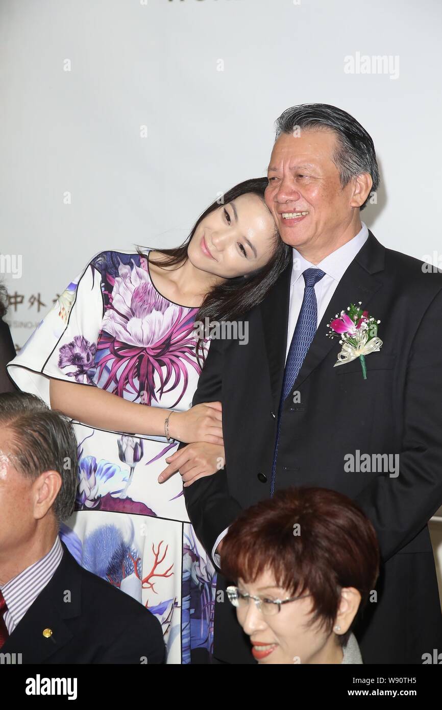 Chinese actress Tang Wei, back left, poses with her father Tang Yuming ...