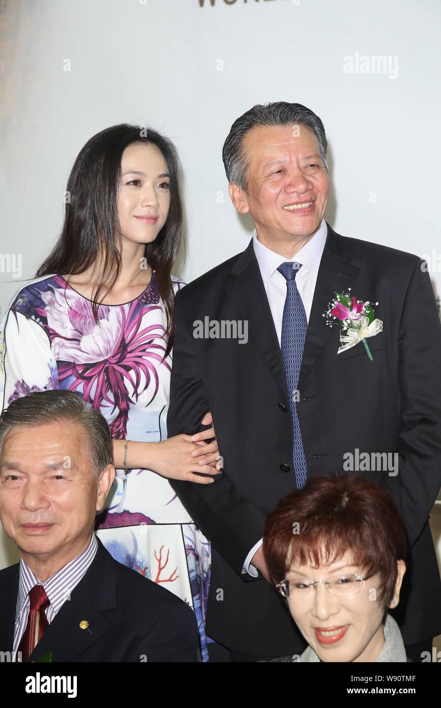 Chinese actress Tang Wei, back left, poses with her father Tang Yuming ...
