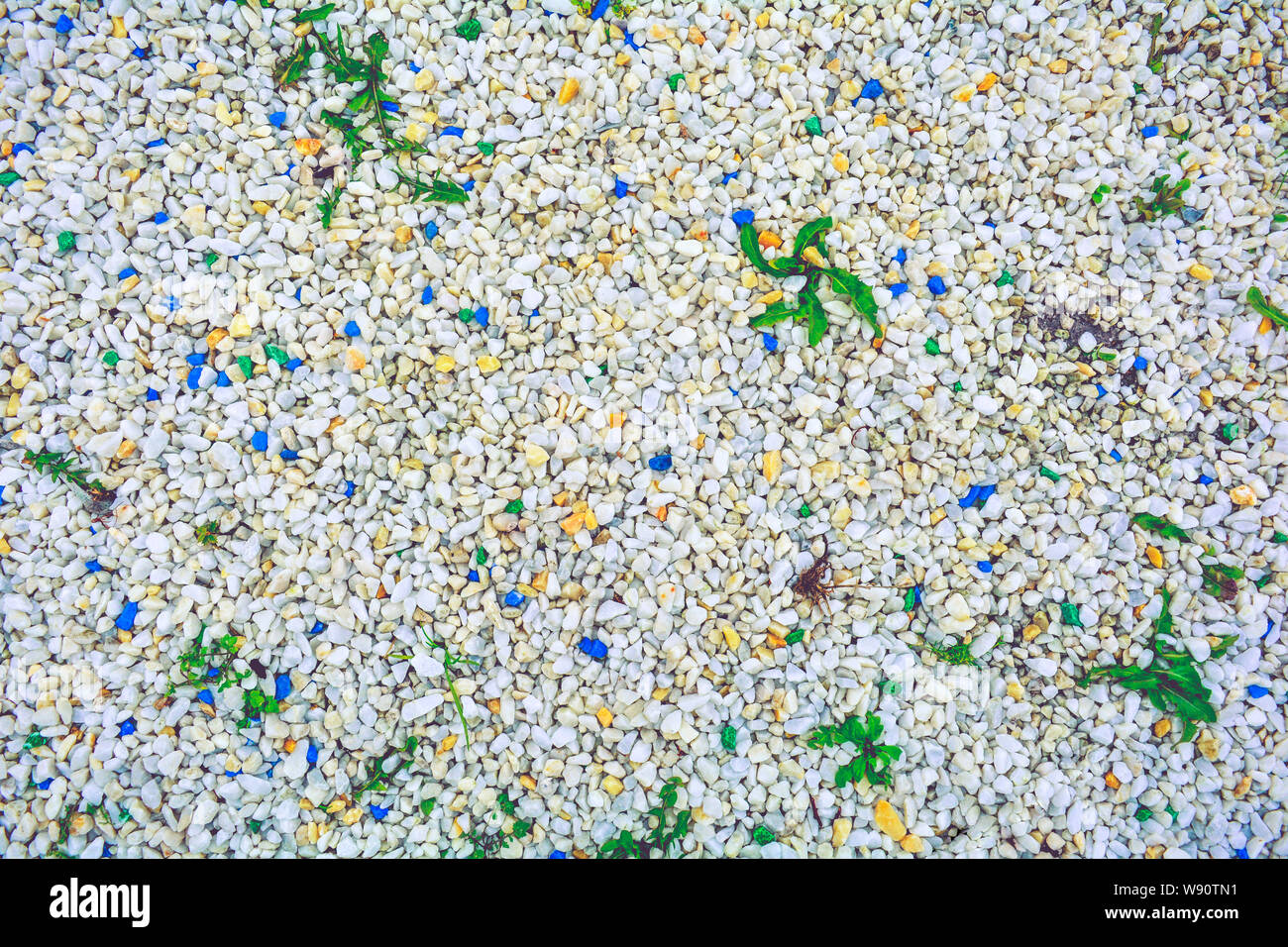 Gravel texture of white, yellow, blue small natural stone rubble with ...