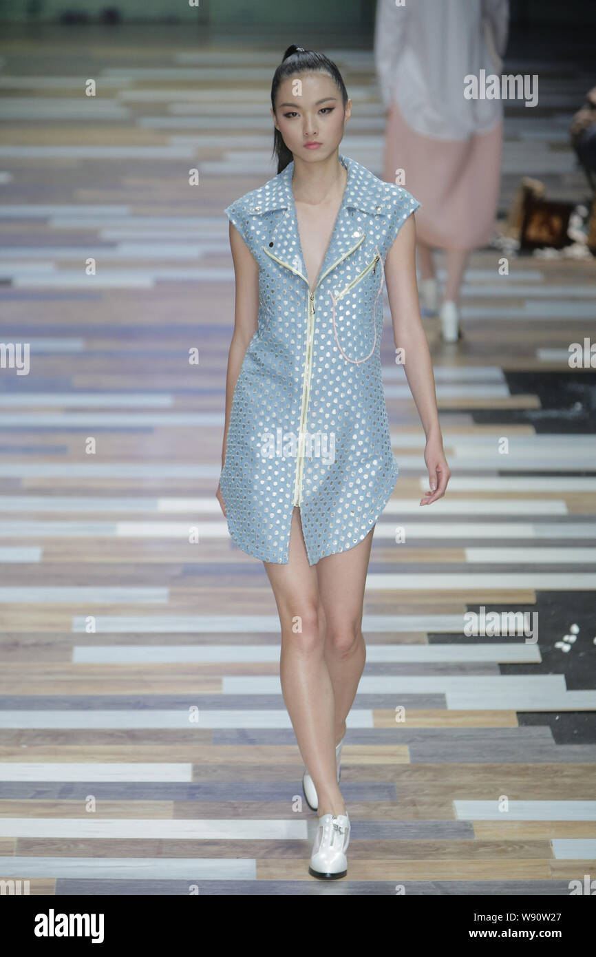 A model displays a new creation by designers Wu Xuewei and He Wei at ...