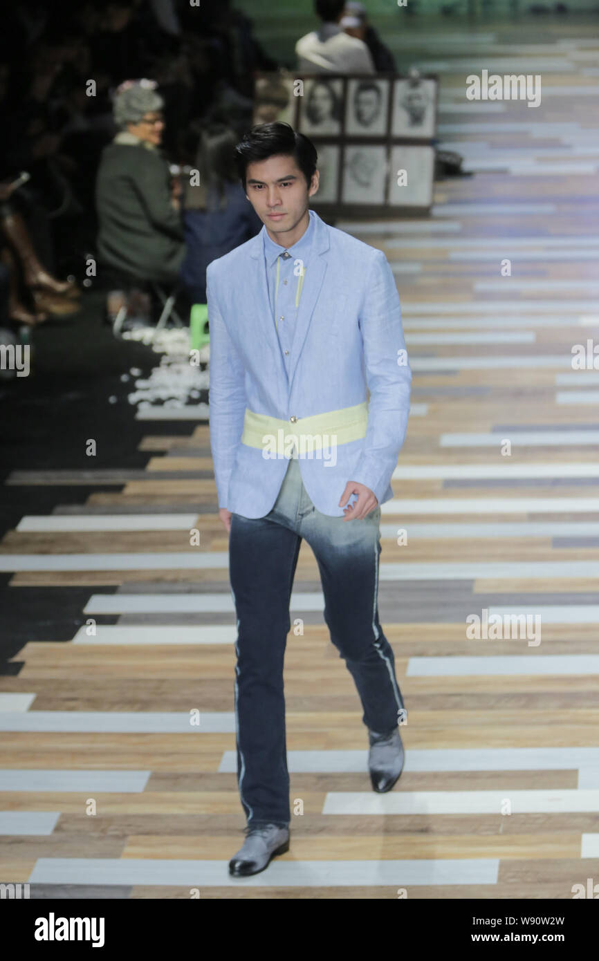 A model displays a new creation by designers Wu Xuewei and He Wei at ...