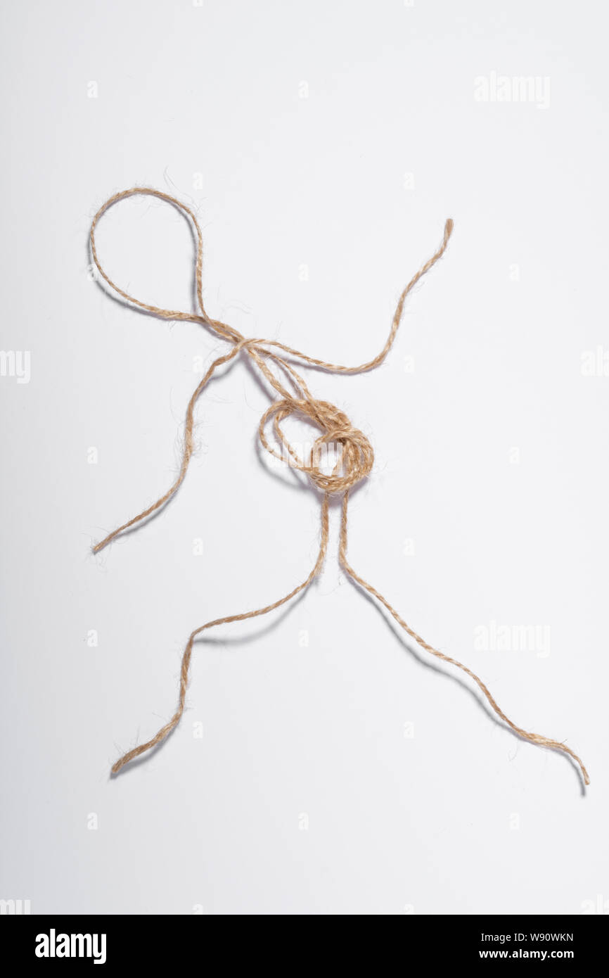 Illustrative (stickman) person using brown string. Photographed on ...