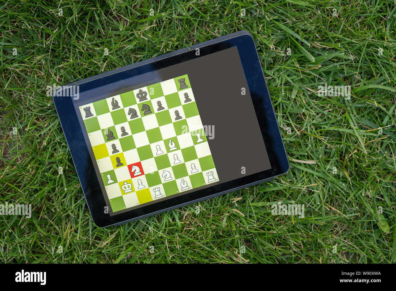 Child playing tablet computer chess hi-res stock photography and images ...