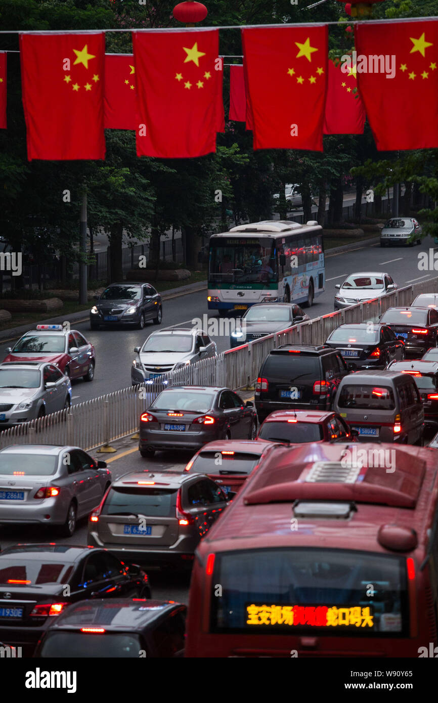 Masses of vehicles move slowly in a traffic jam on a road decorated ...