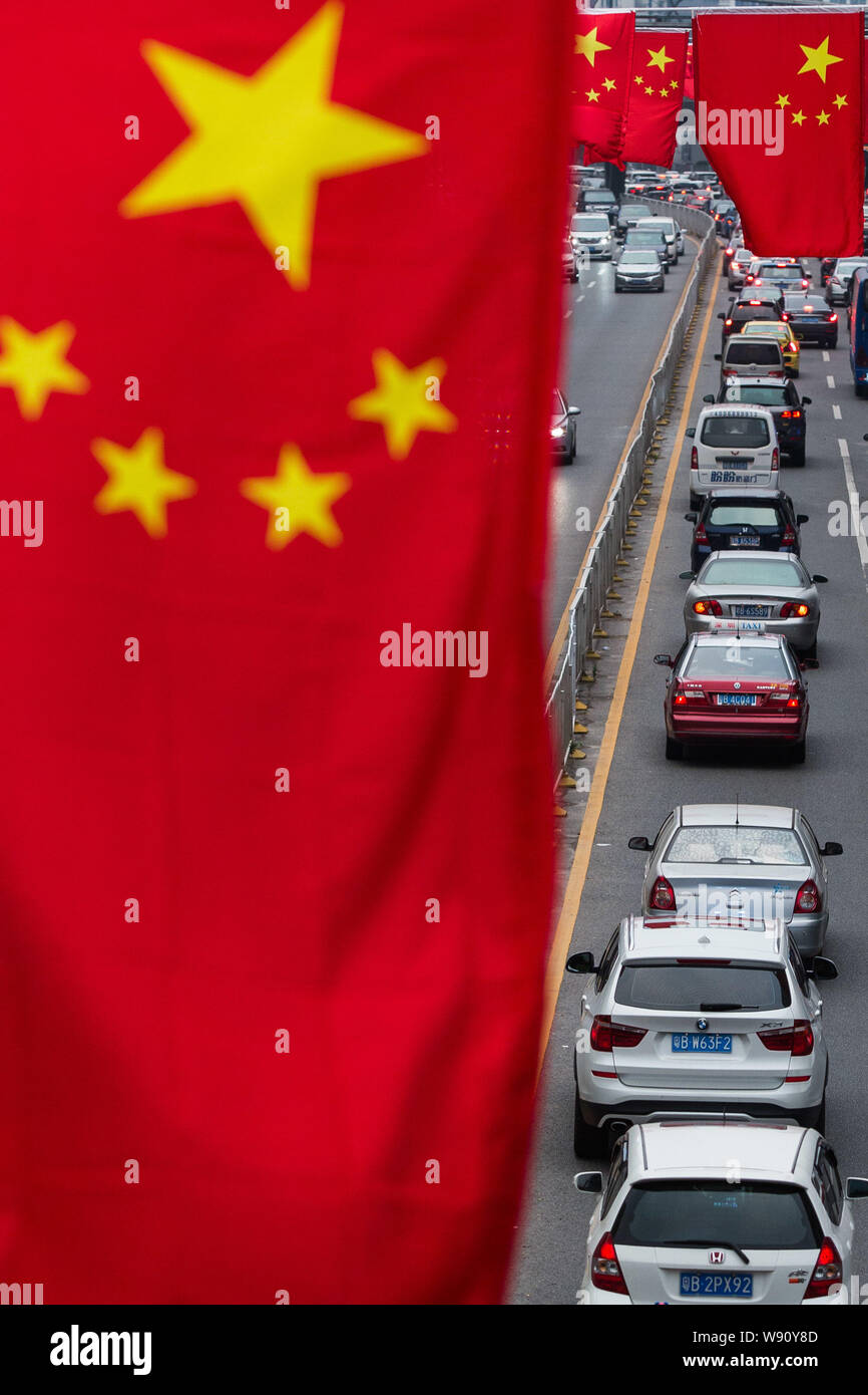 Masses of vehicles move slowly in a traffic jam on a road decorated ...