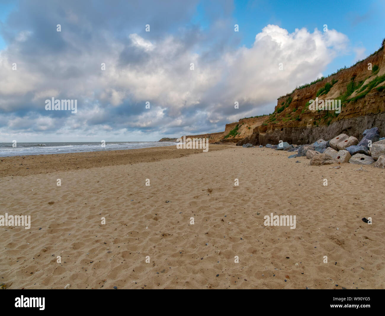 On Happisburgh beach, in Norfolk, under the soft erroded cliffs Stock ...