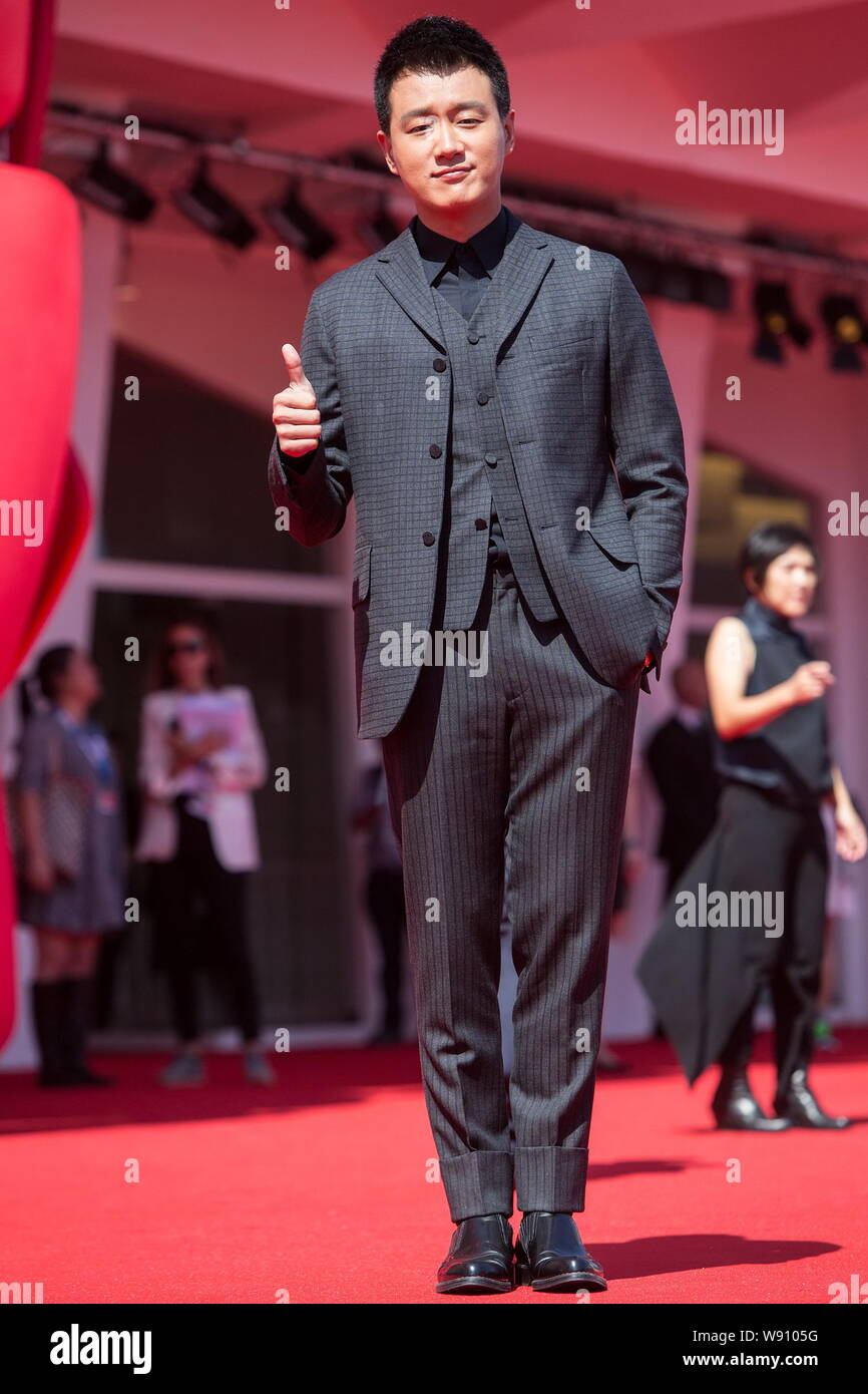 Chinese actor Tong Dawei poses on the red carpet as he arrives for the ...