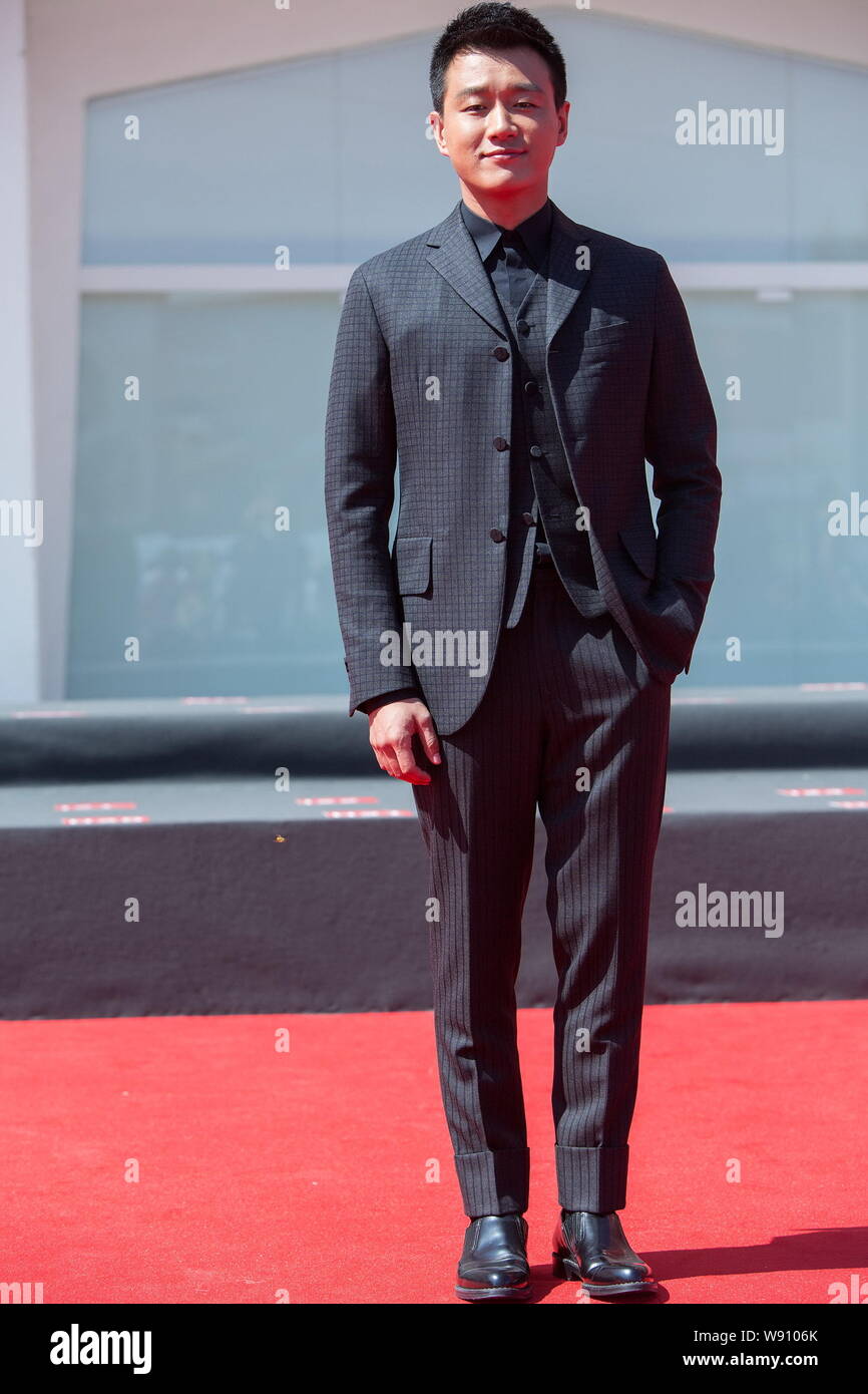 Chinese actor Tong Dawei poses on the red carpet as he arrives for the ...