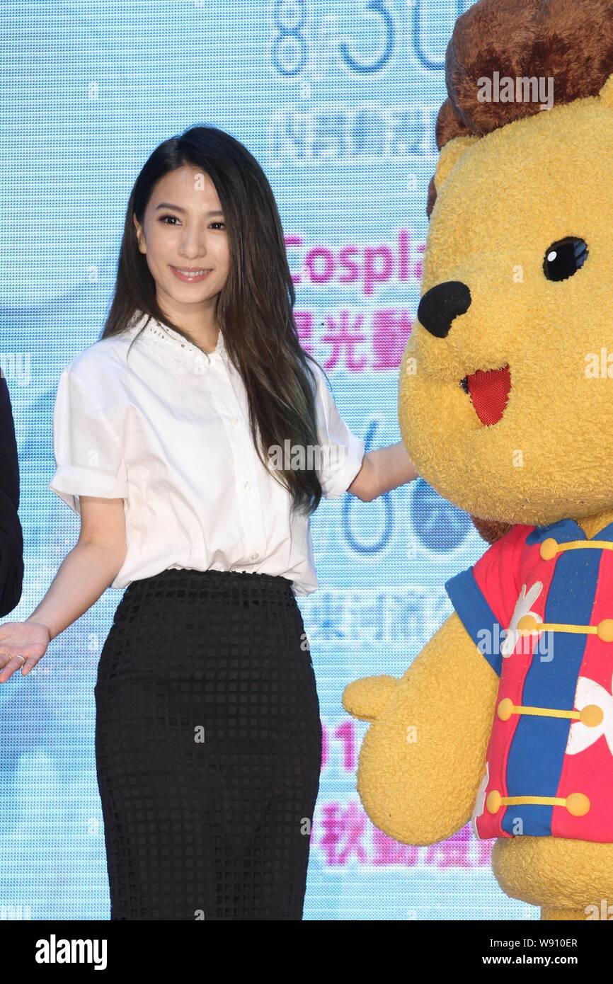 Hebe Tien of Taiwanese girl group S.H.E poses with a mascot during a ...