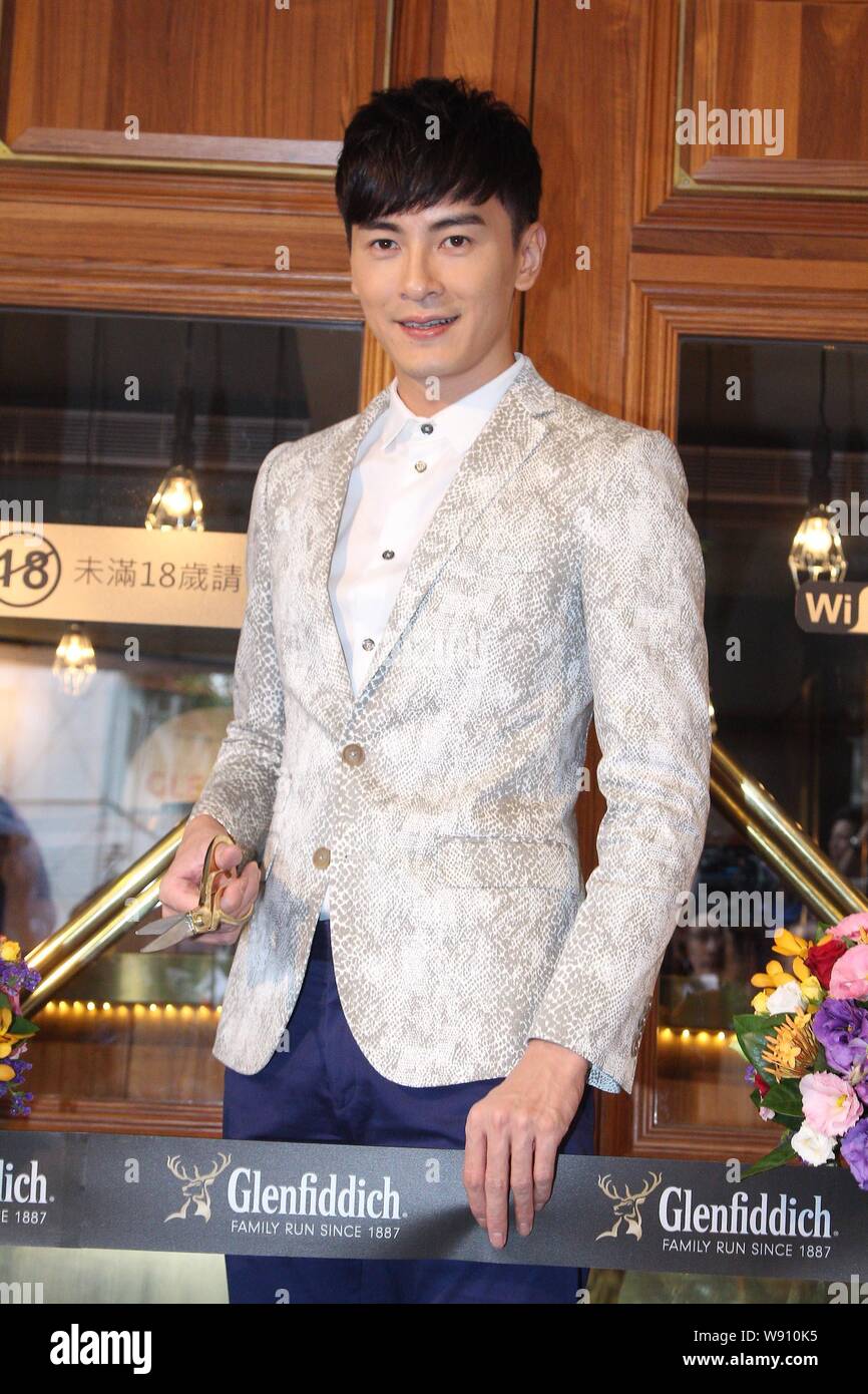 Taiwanese actor Joseph Cheng prepares to cut the ribbon during the ...