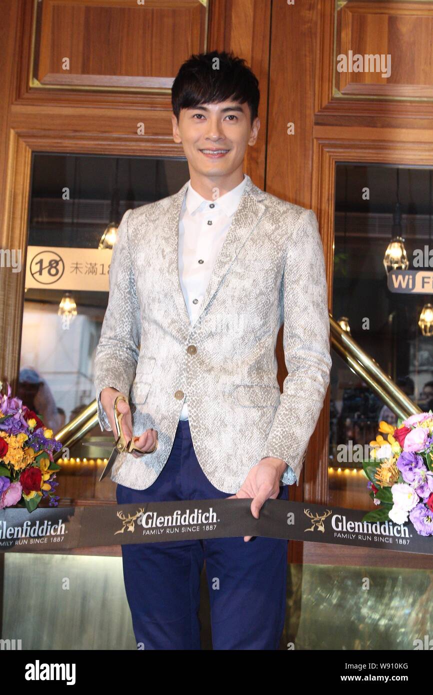 Taiwanese actor Joseph Cheng prepares to cut the ribbon during the ...
